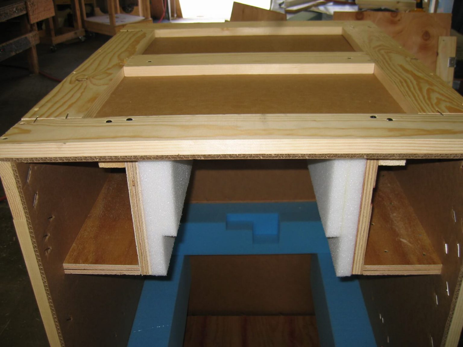 Hybrid wood and corrugated protective packaging for lightness without ...